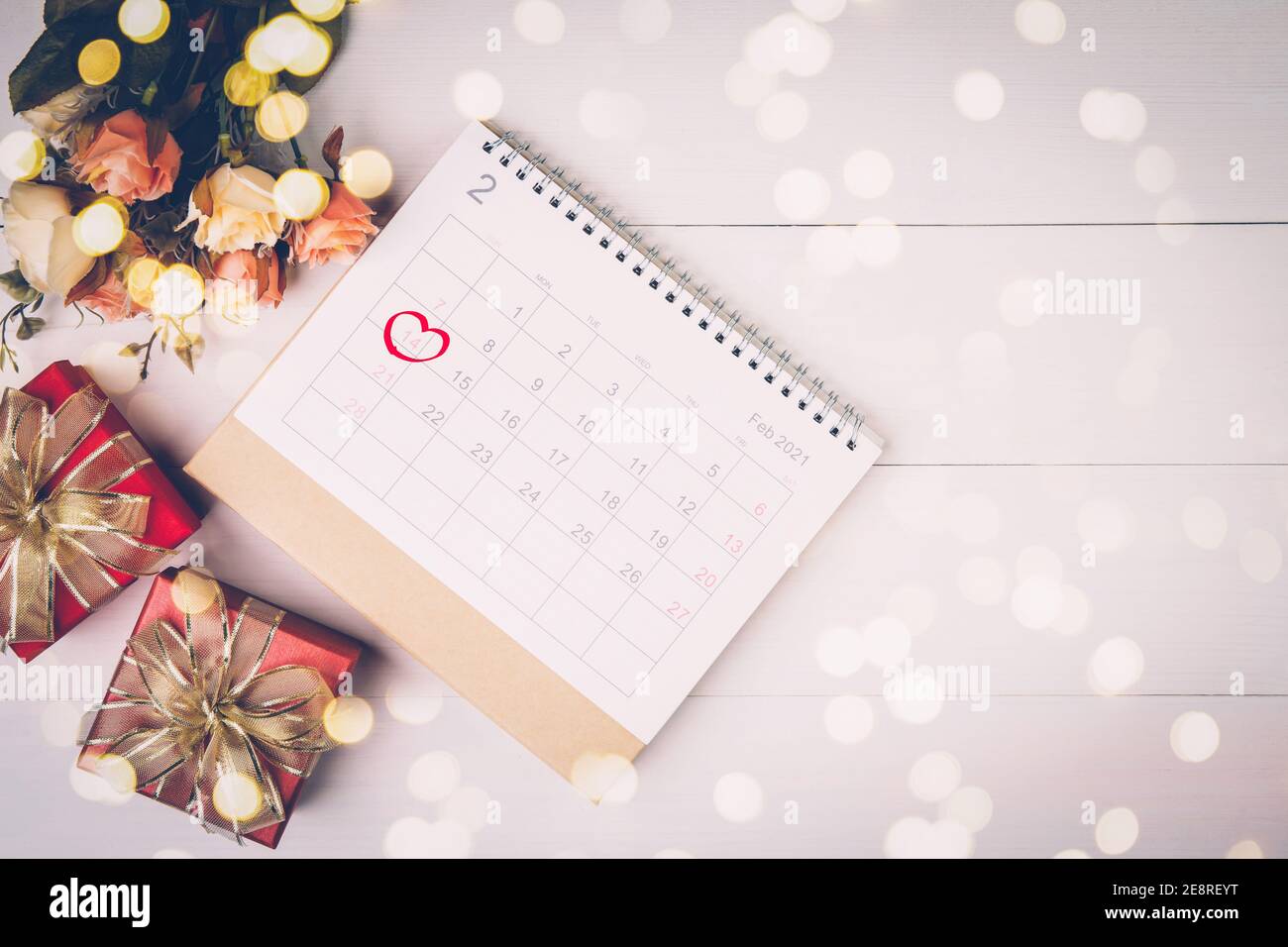 Calendar and flower with memo 14 February Valentine day on desk with ...