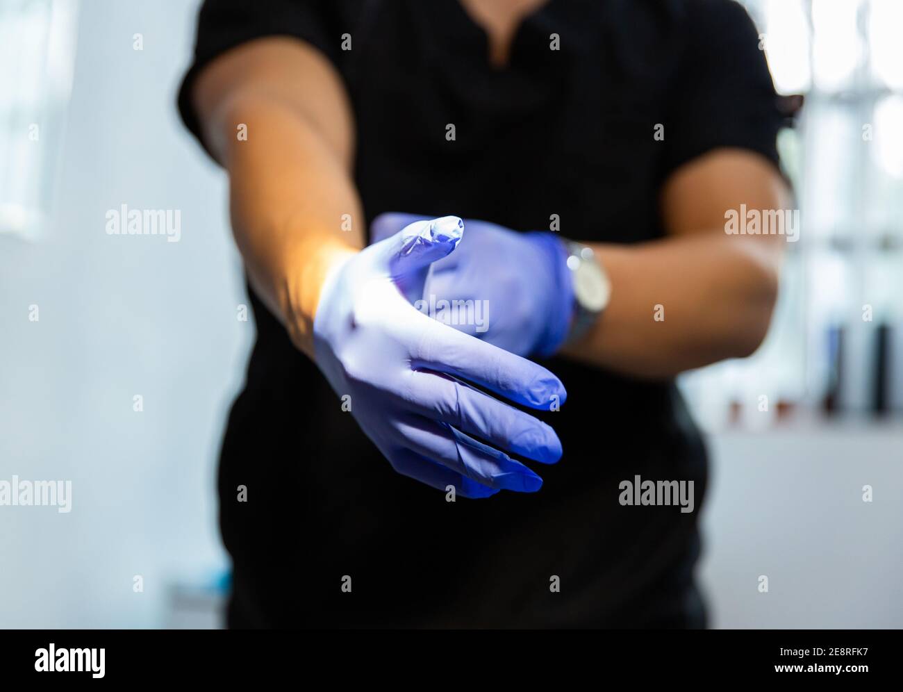 Doctor wearing blue latex gloves. Front view Stock Photo - Alamy