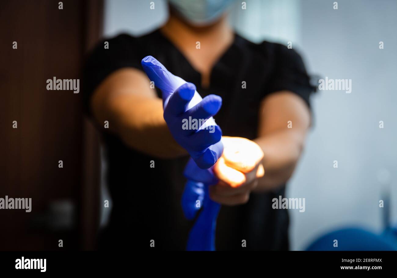 Doctor wearing blue latex gloves. Front view Stock Photo - Alamy