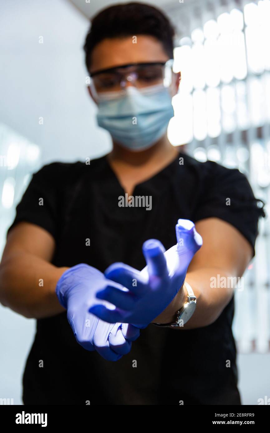 Doctor wearing blue latex gloves. Front view Stock Photo - Alamy