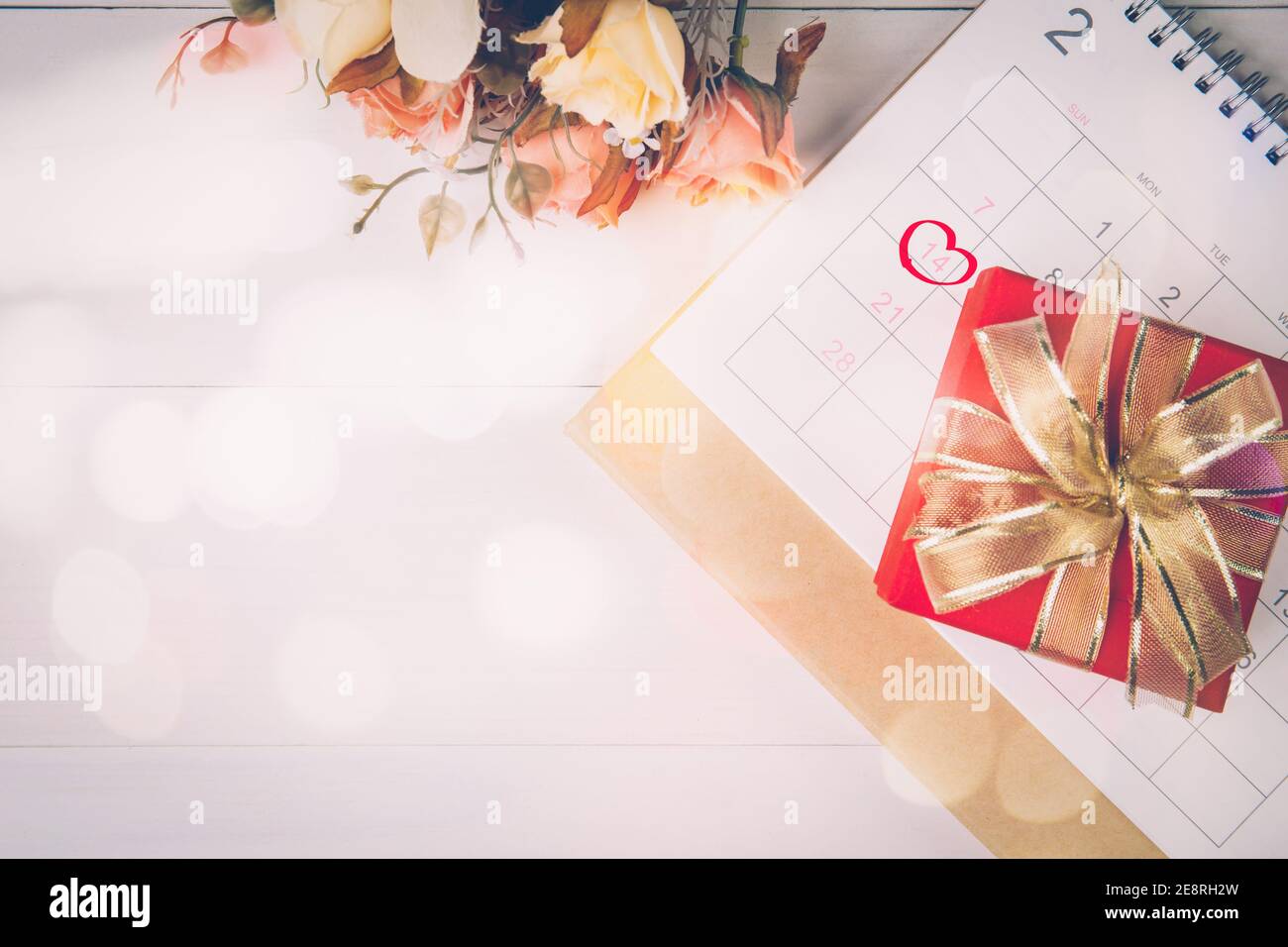 Calendar and flower with memo 14 February Valentine day on desk with ...