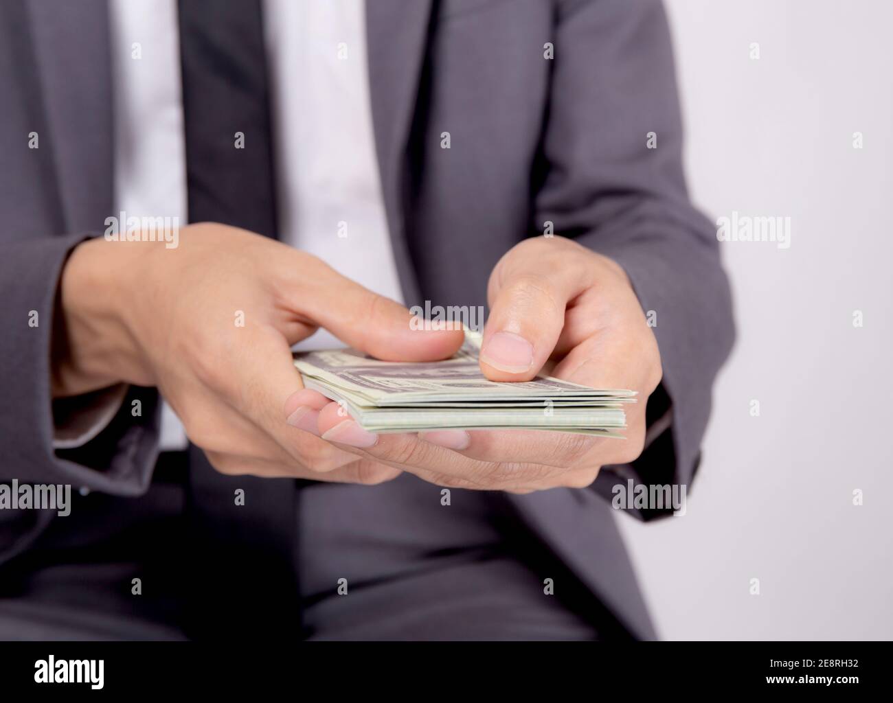 Hand of business man giving money isolated on white background, finance ...