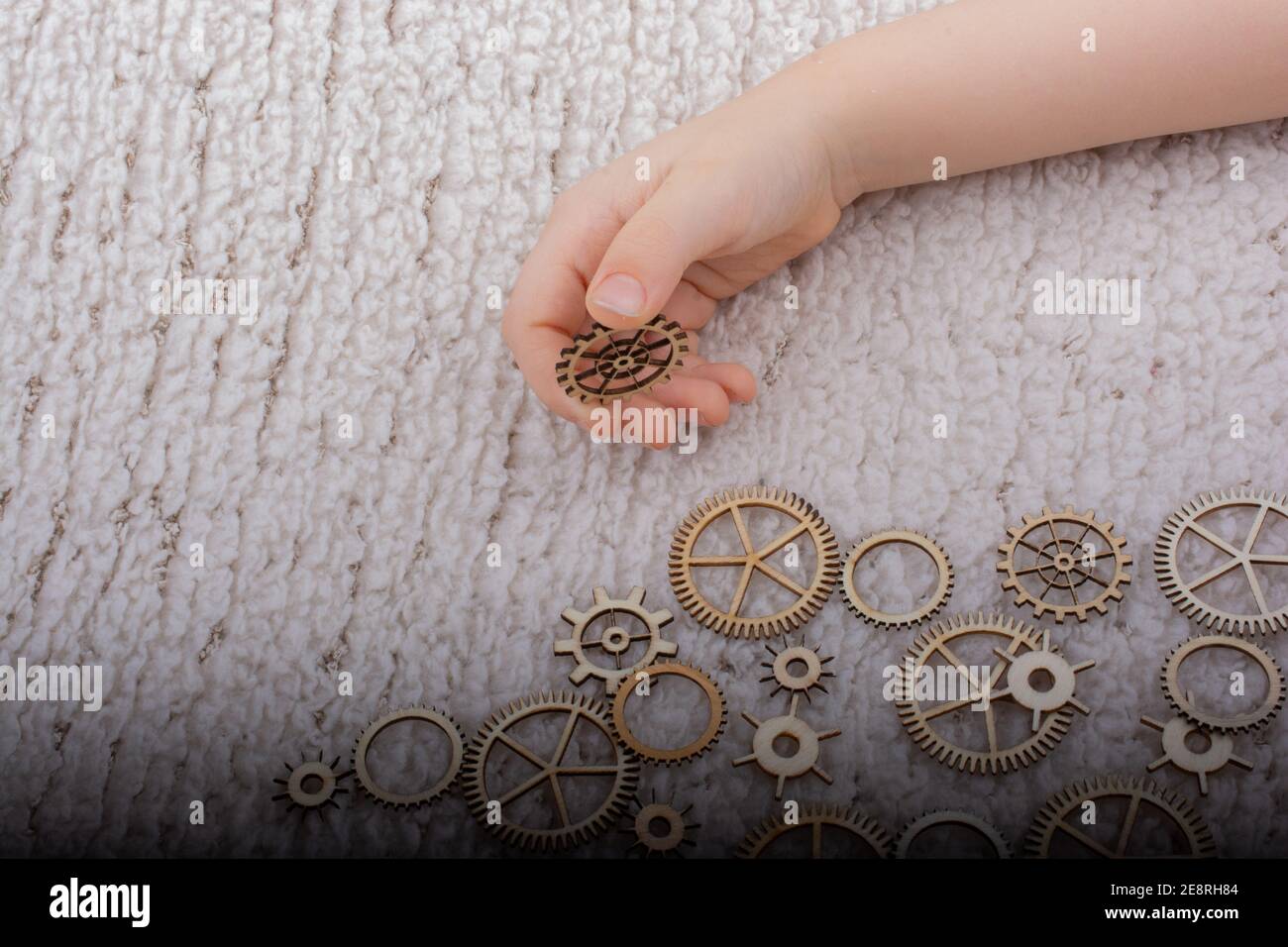 Hand holding gear wheels as the concept of mechanism Stock Photo - Alamy