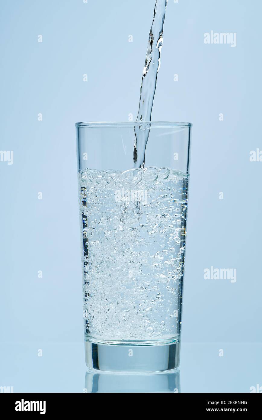 Pouring water. Pouring fresh clean drinking water to glass Stock Photo ...