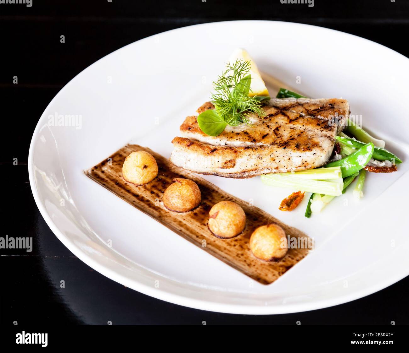 Fillet sea bass with vegetable and potatoes Stock Photo - Alamy