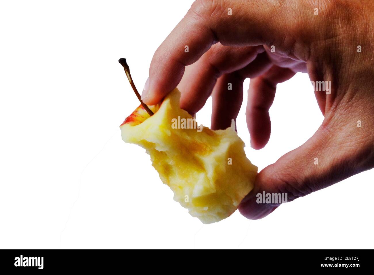 Man's hand holding an apple core with clipping path isolated on white ...