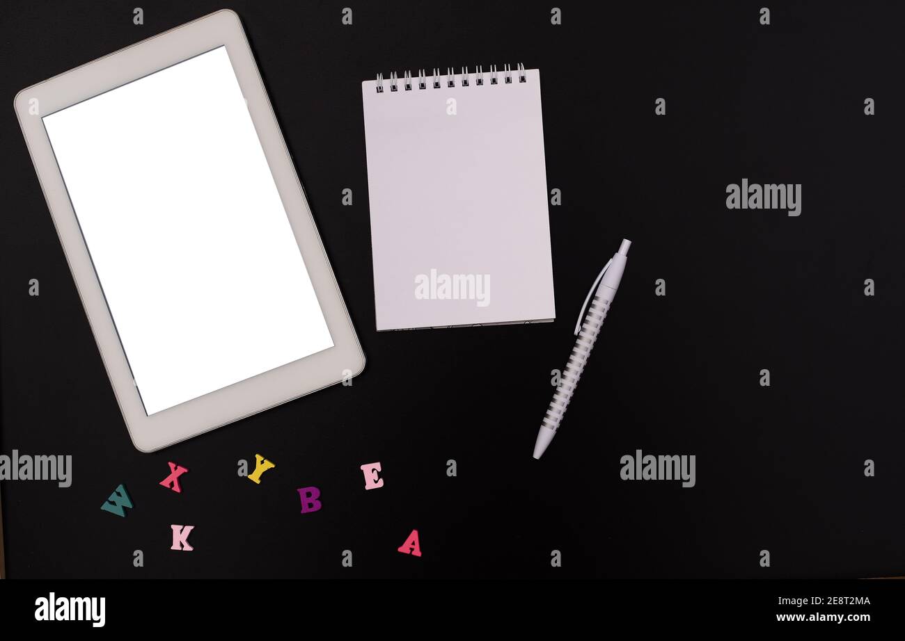 Online courses. The study of the English language. A tablet with a copy of the space, a blank ...