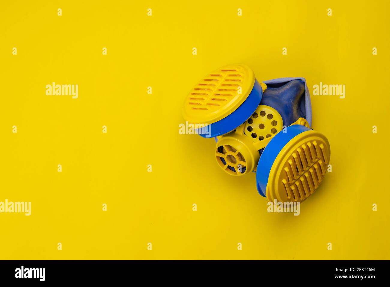 Respirator type half mask with replaceable filters on yellow background ...