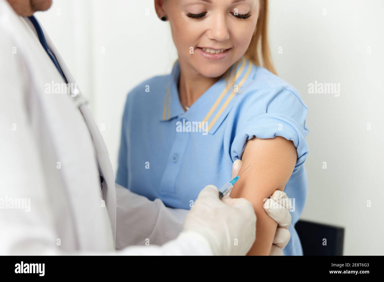 male doctor giving an injection to the patient's arm health vaccine ...