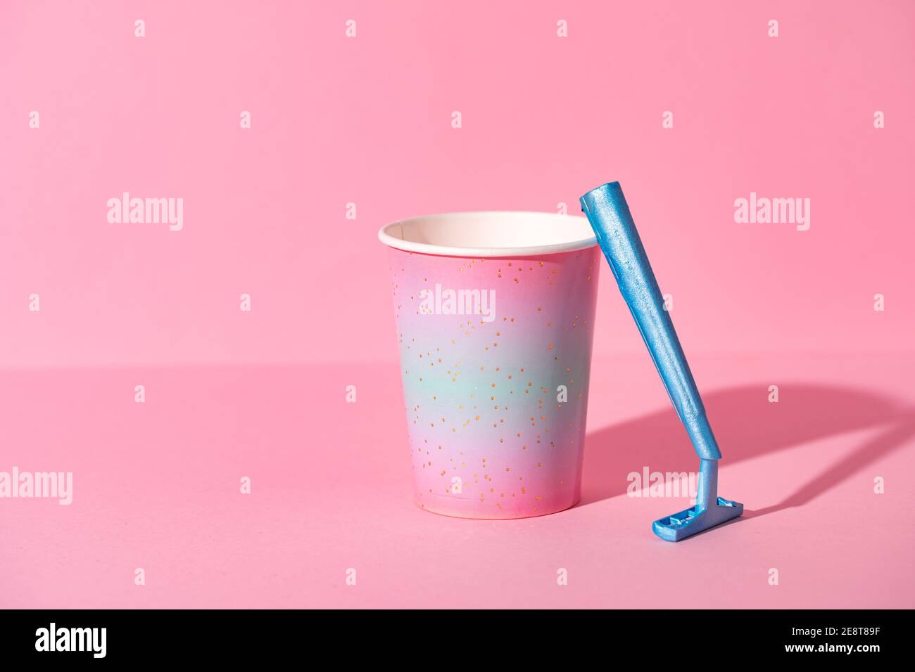 Female disposable razor in a cup, studio shot Stock Photo - Alamy