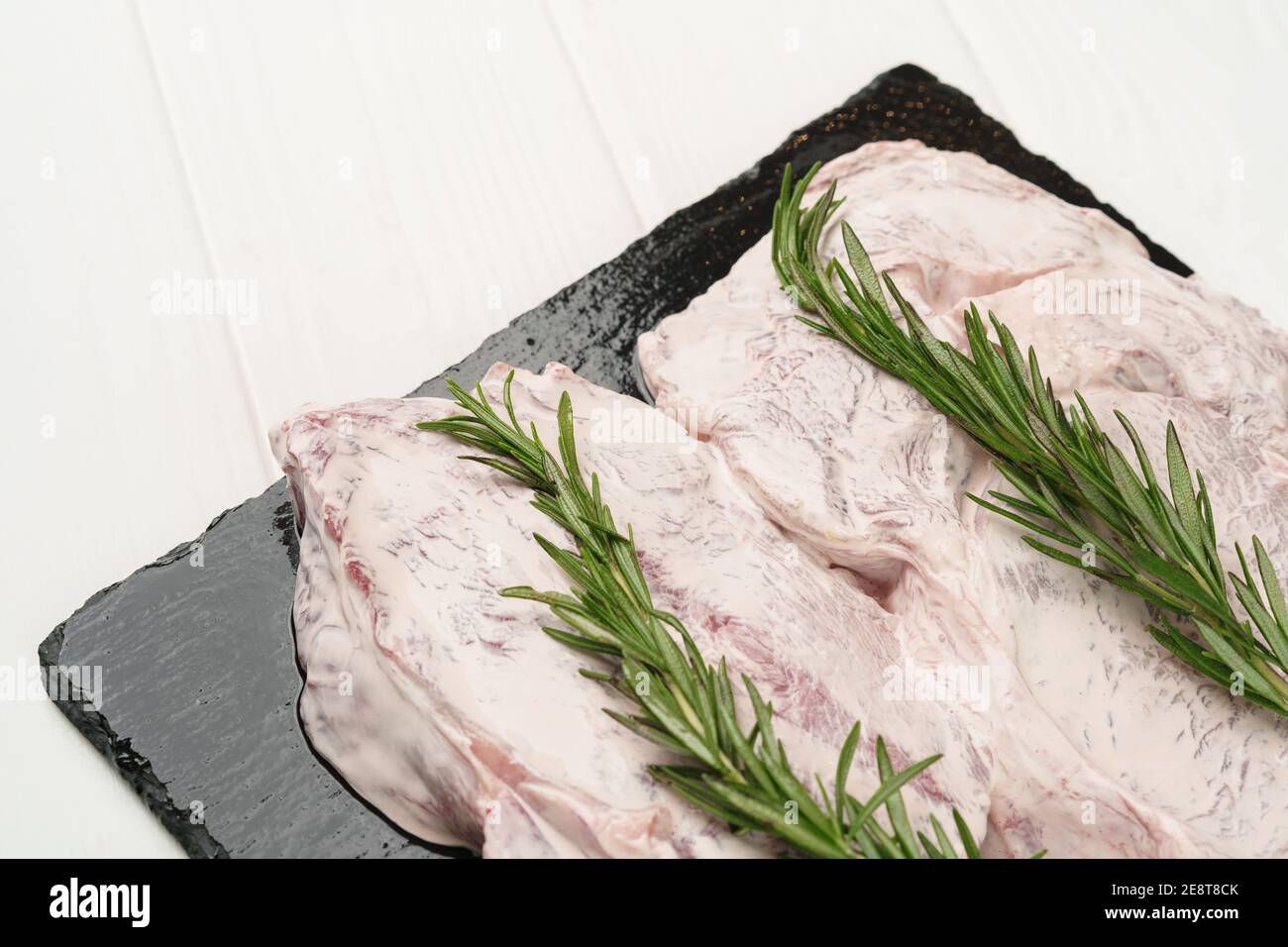 Two raw marinated beef steaks hi-res stock photography and images - Alamy