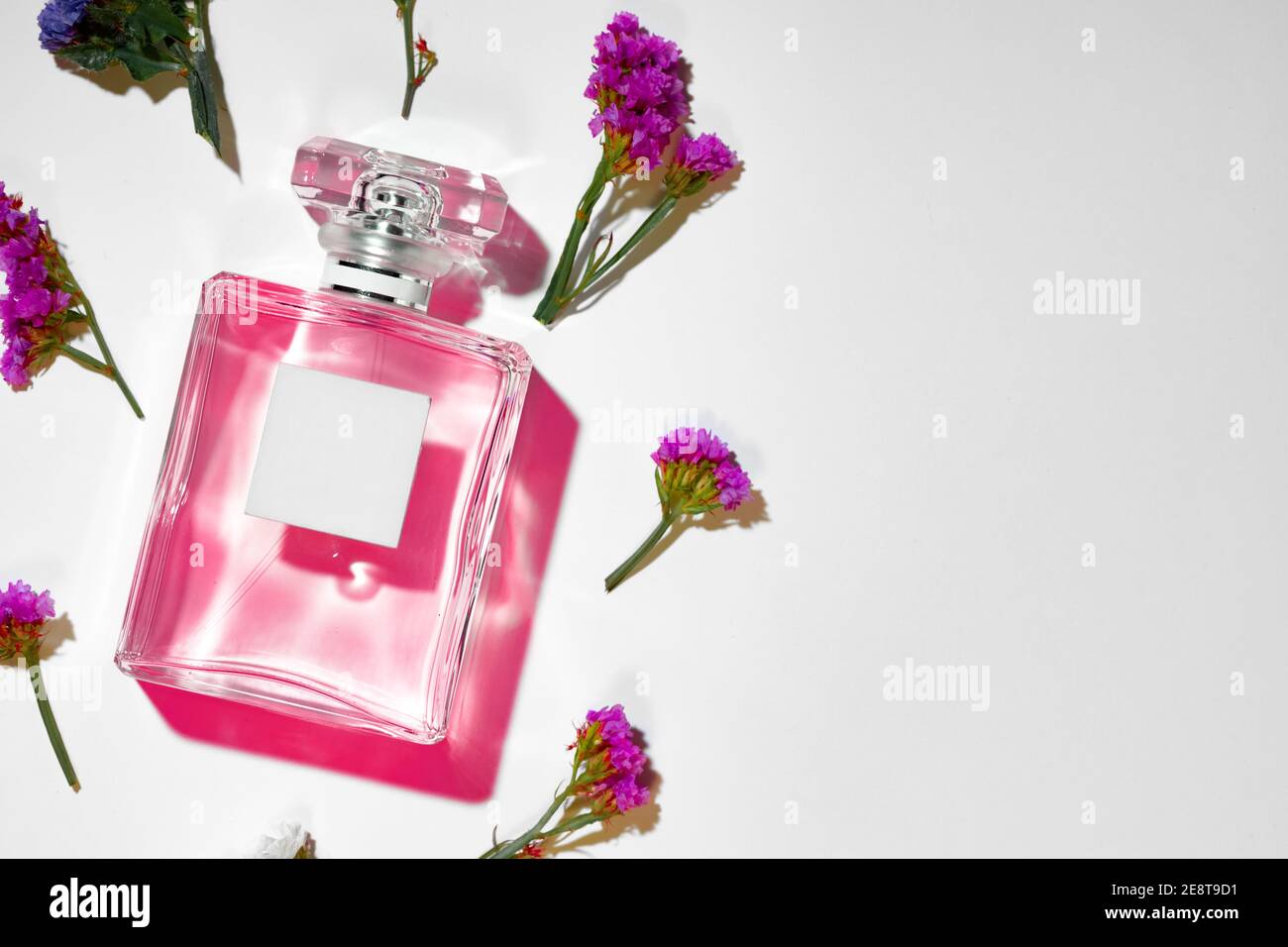 Perfume bottle for women in flower buds Stock Photo - Alamy