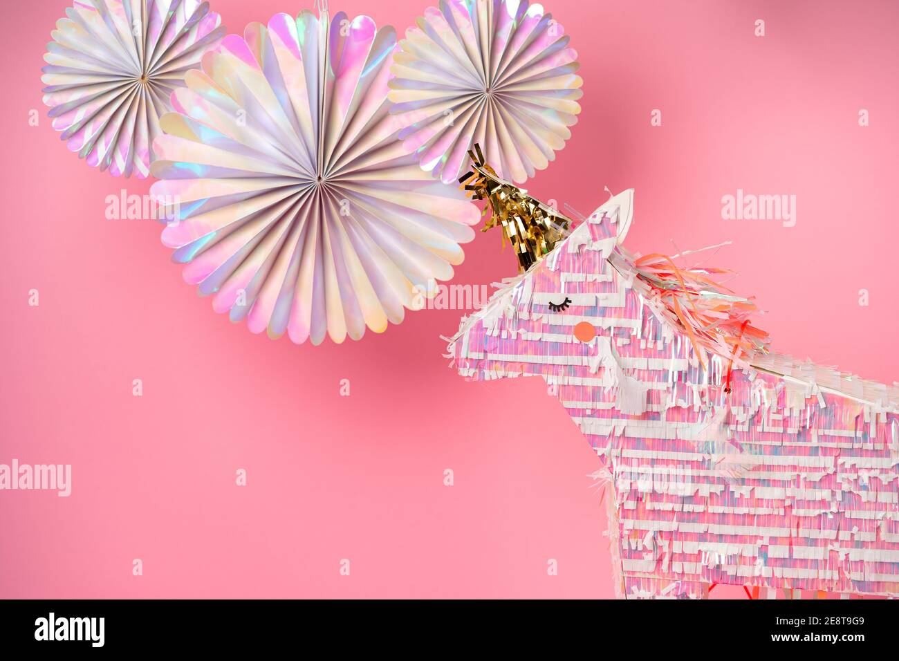 Unicorn pinata for kids party on pink background Stock Photo - Alamy