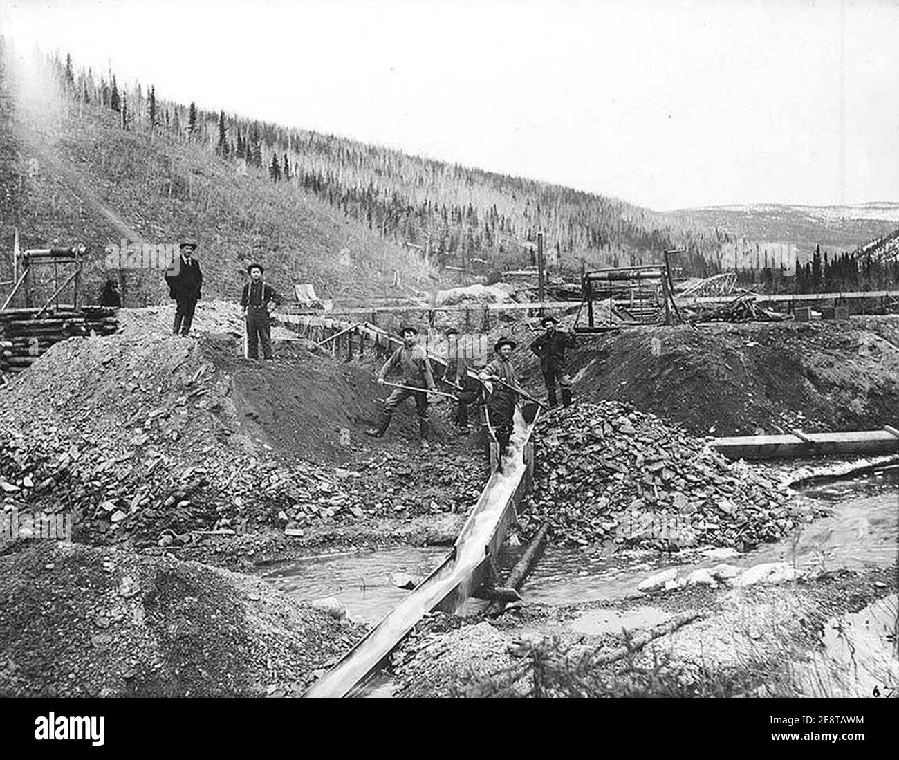 Mining operation showing six miners beside a flume, Hunker Creek, nd ...