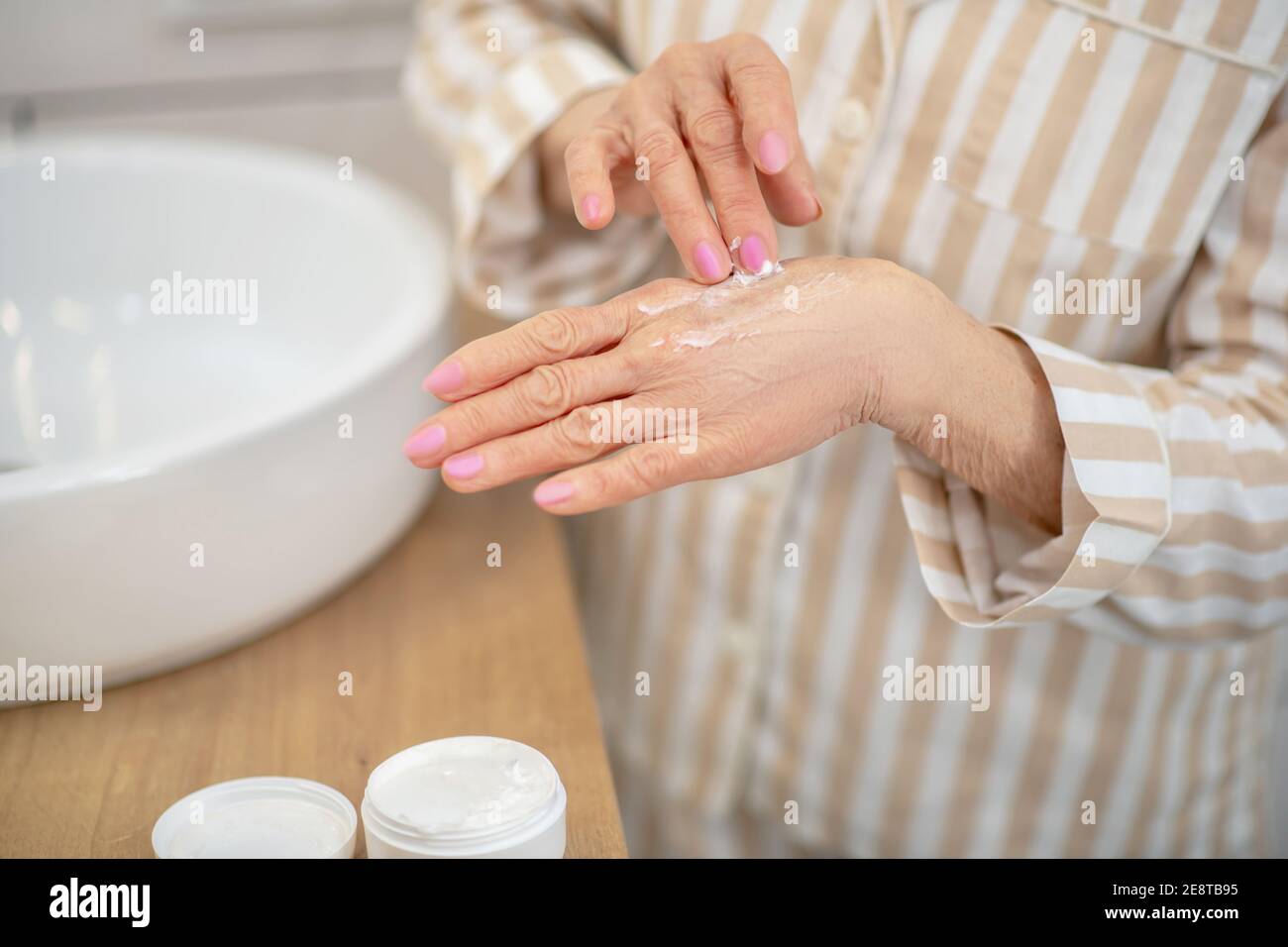 Elderly hands cream hi-res stock photography and images - Alamy
