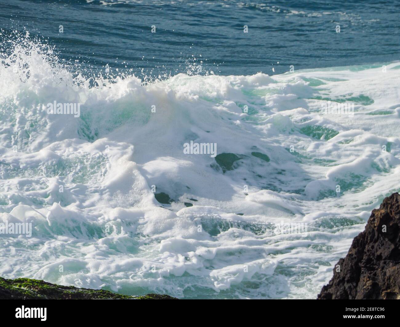 Foamy white choppy sea water waves crashing onto rocks, Pacific Ocean ...