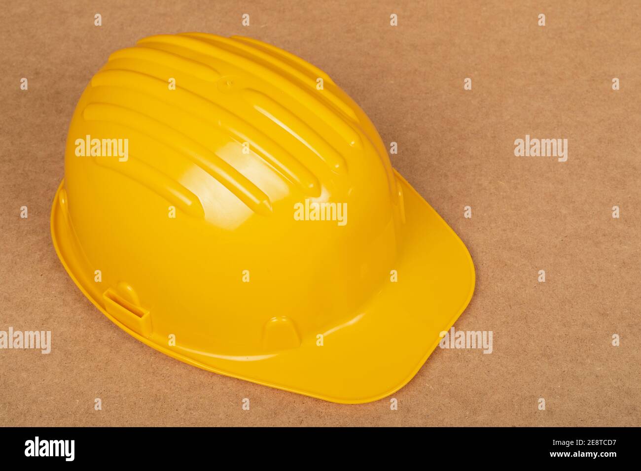 Professional yellow hard hat on wooden background Safety at work ...