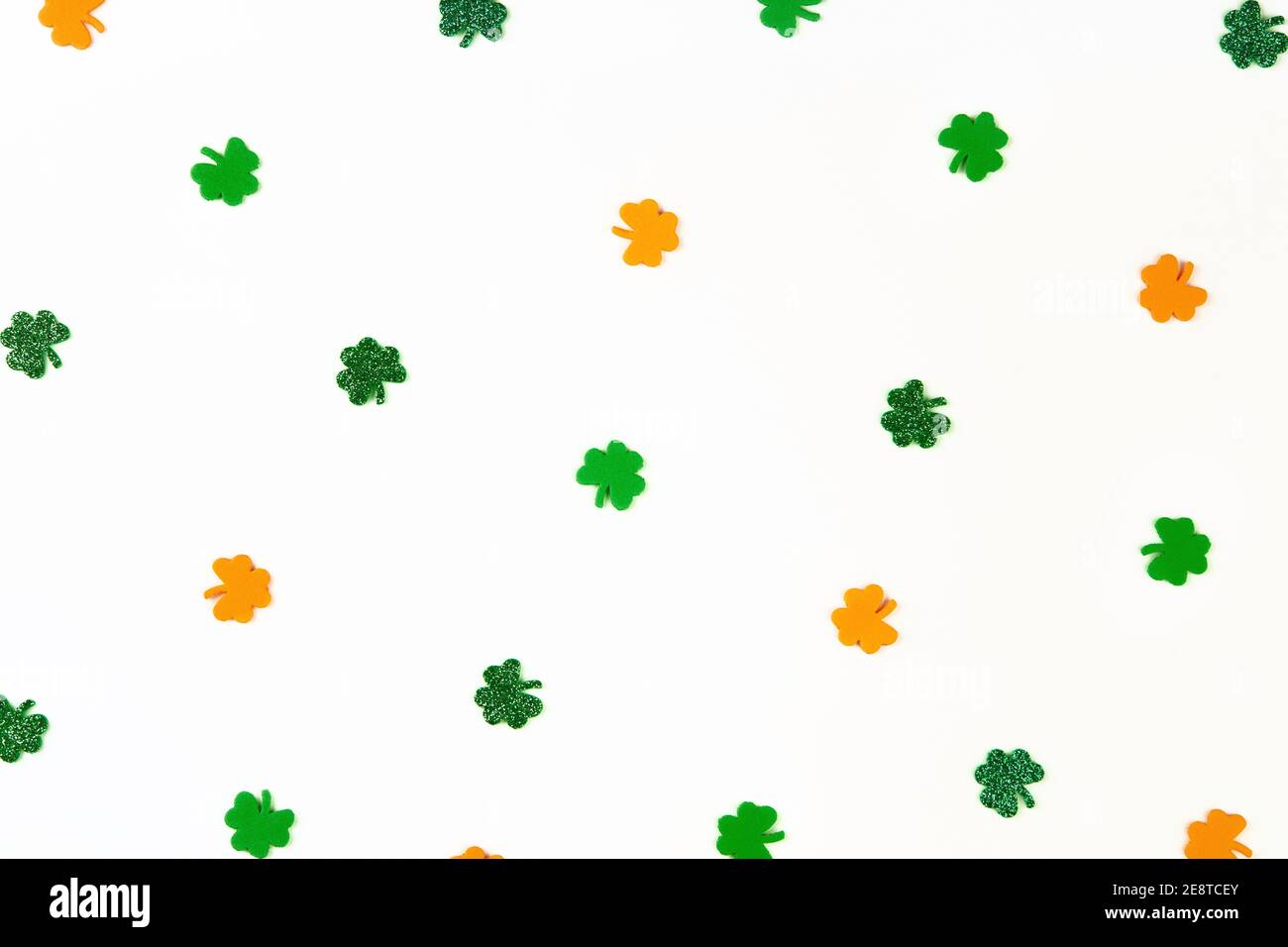 green orange and white shamrock confetti sparse on white background ...