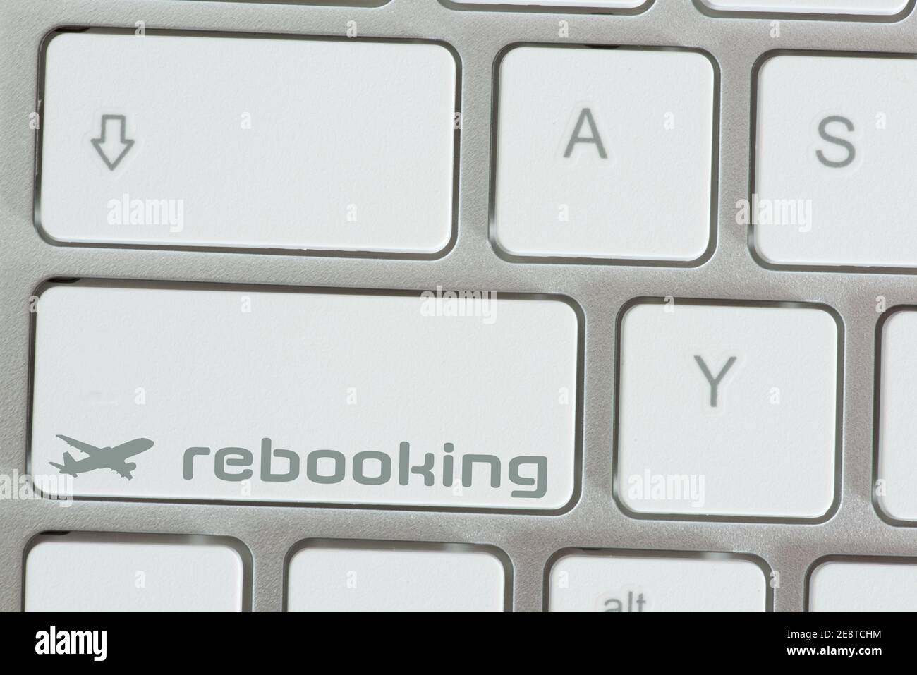 A computer and key for rebooking a flight Stock Photo - Alamy