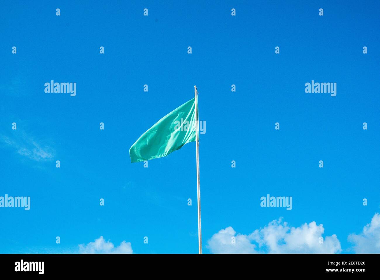 Green flag pole posted to signal the sea water conditions are safe in ...