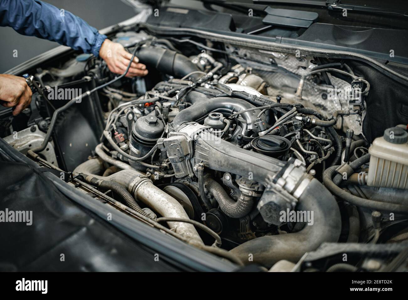 Dirty engine under the hood of a car Stock Photo - Alamy