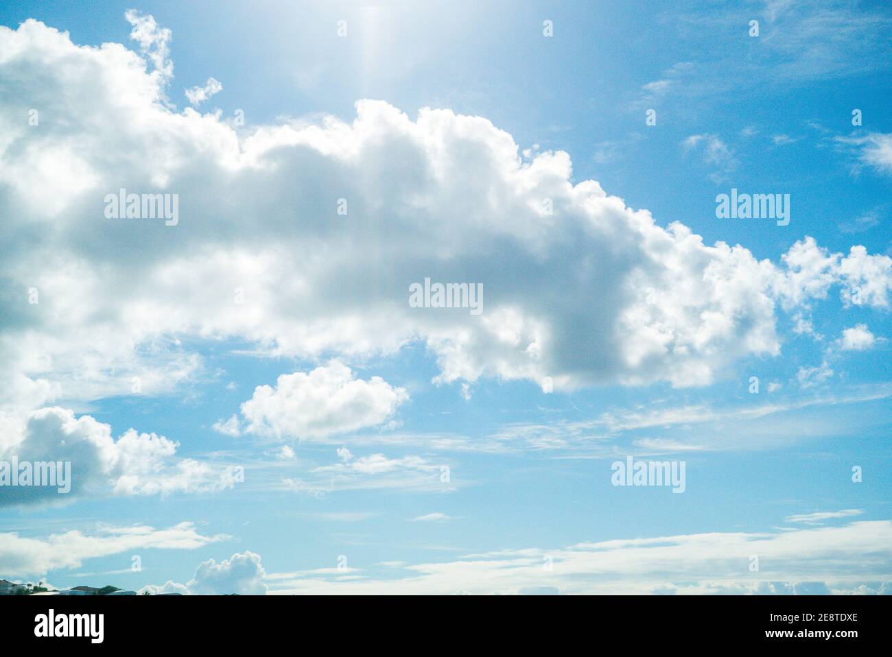 Beautiful white cloudy sky with the sun rising Stock Photo - Alamy