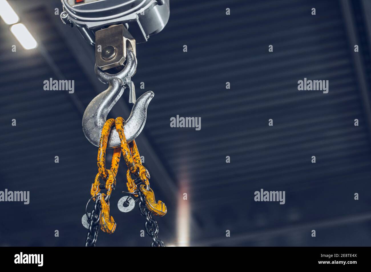 Huge hook with steel chain in a factory Stock Photo - Alamy