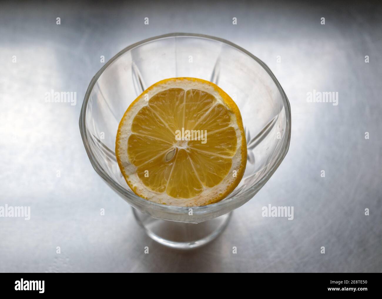 cut lemon in a glass container, cooking additives Stock Photo - Alamy