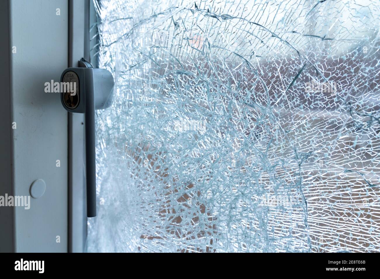 Broken balcony glass door window with shattered glass Stock Photo - Alamy