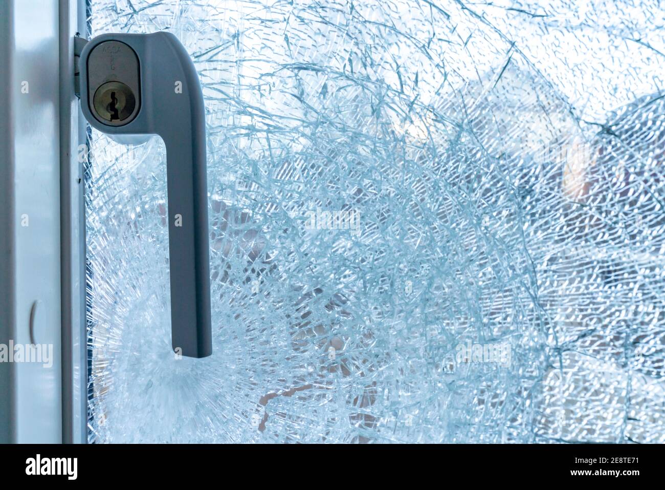 Broken balcony glass door window with shattered glass Stock Photo - Alamy