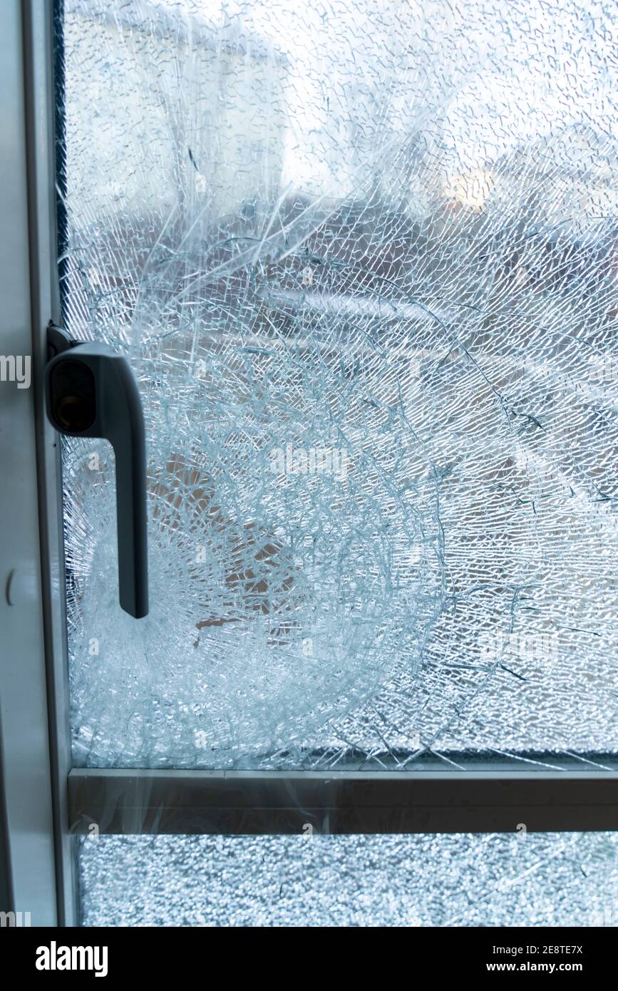 Broken balcony glass door window with shattered glass Stock Photo - Alamy