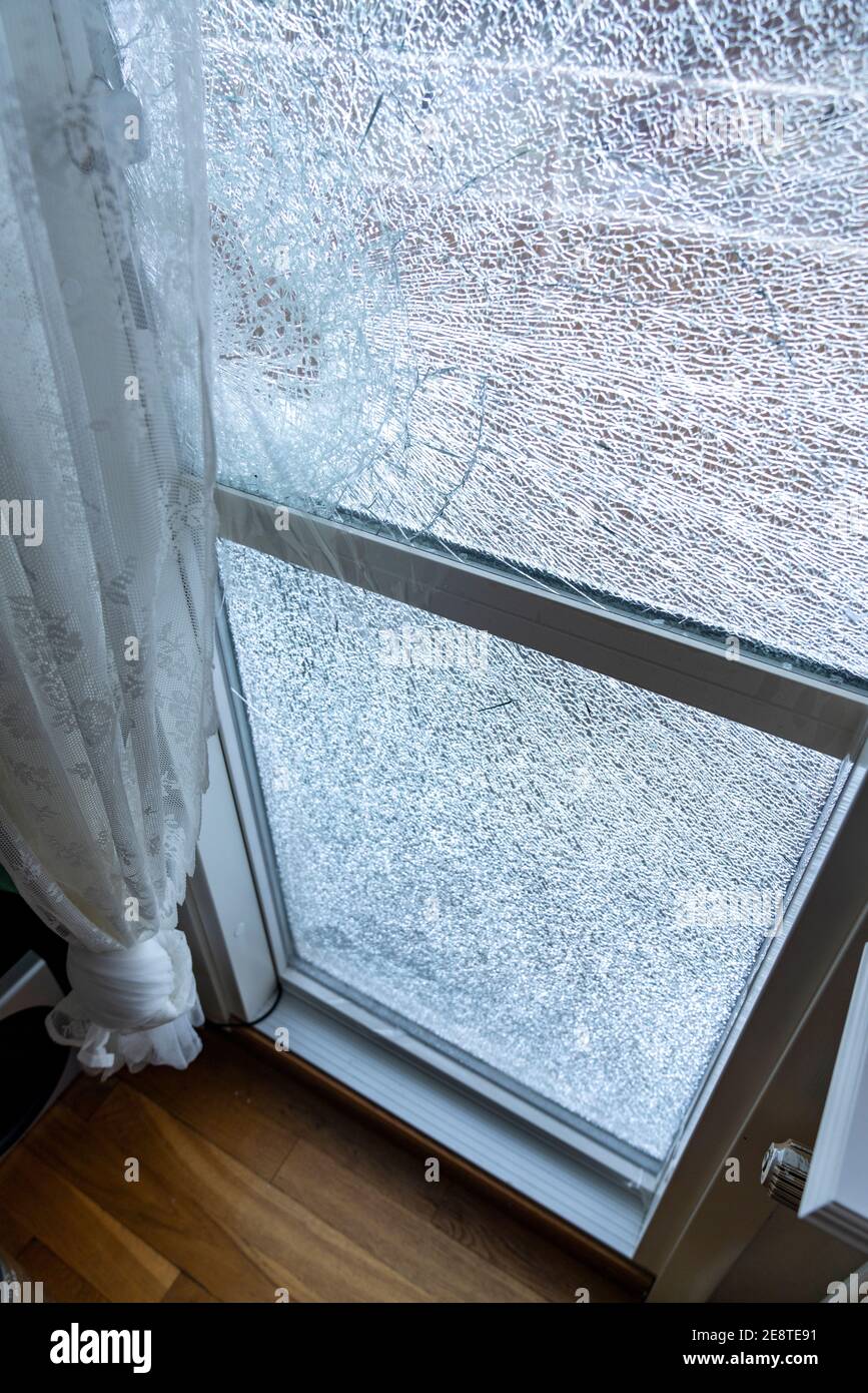 Broken balcony glass door window with shattered glass Stock Photo - Alamy