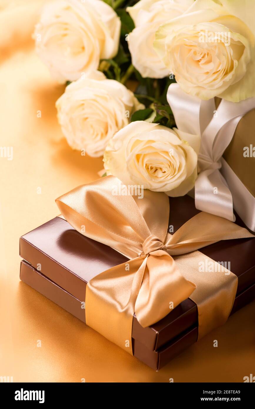 brown box with candies and golden tape close up Stock Photo - Alamy