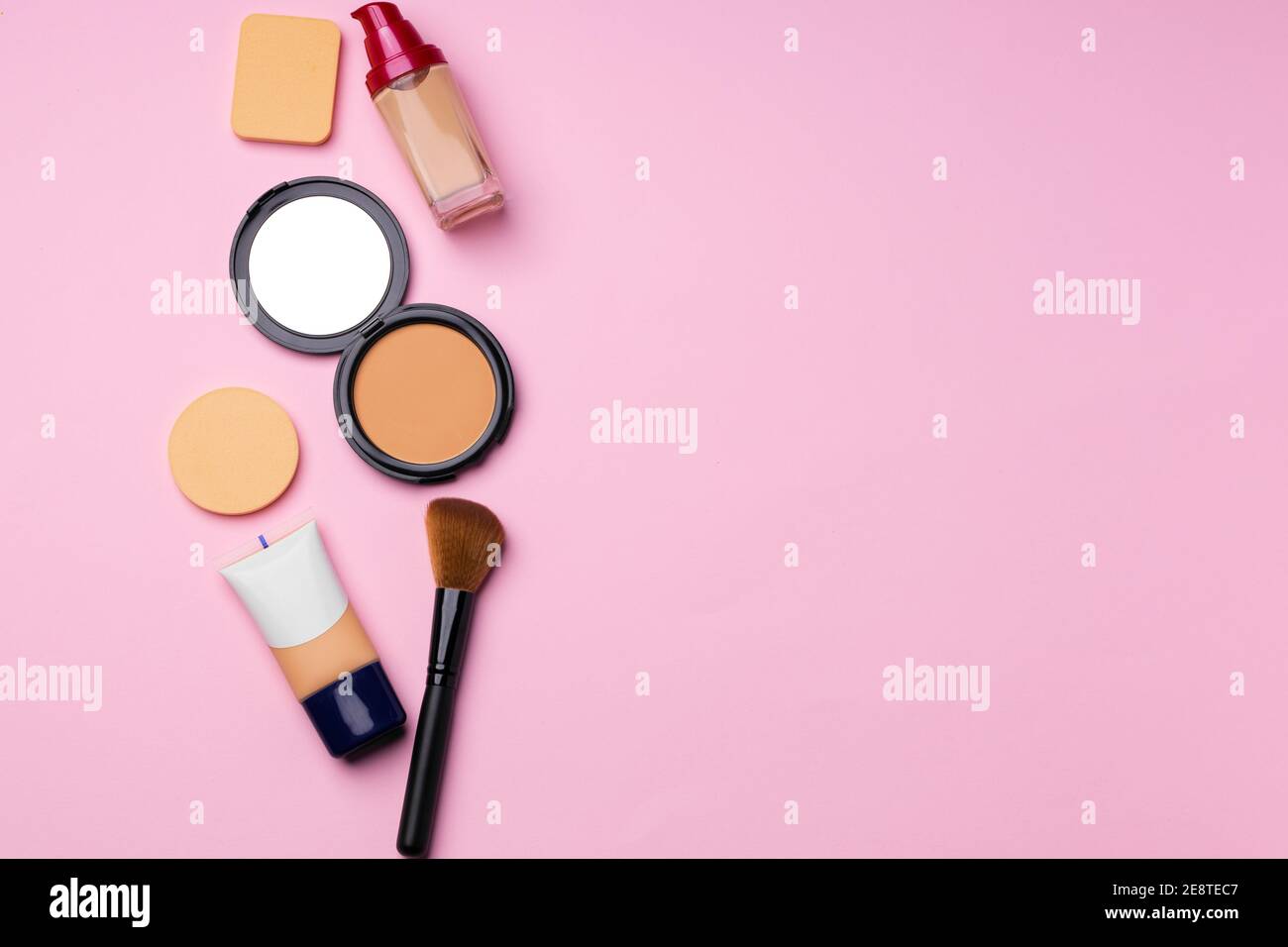 Complexion make up products and brush on pink background Stock Photo ...
