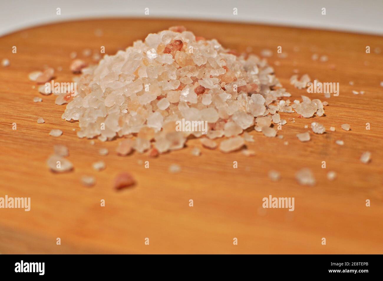 Heap of Himalayan salt on wooden table. Top side view Stock Photo - Alamy