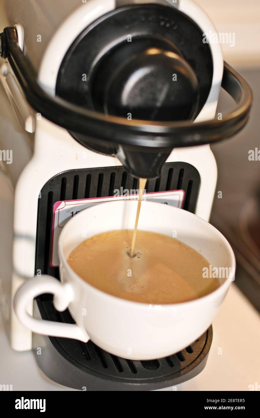 Making a cup of coffee at espresso machine. Front view, vertical Stock ...
