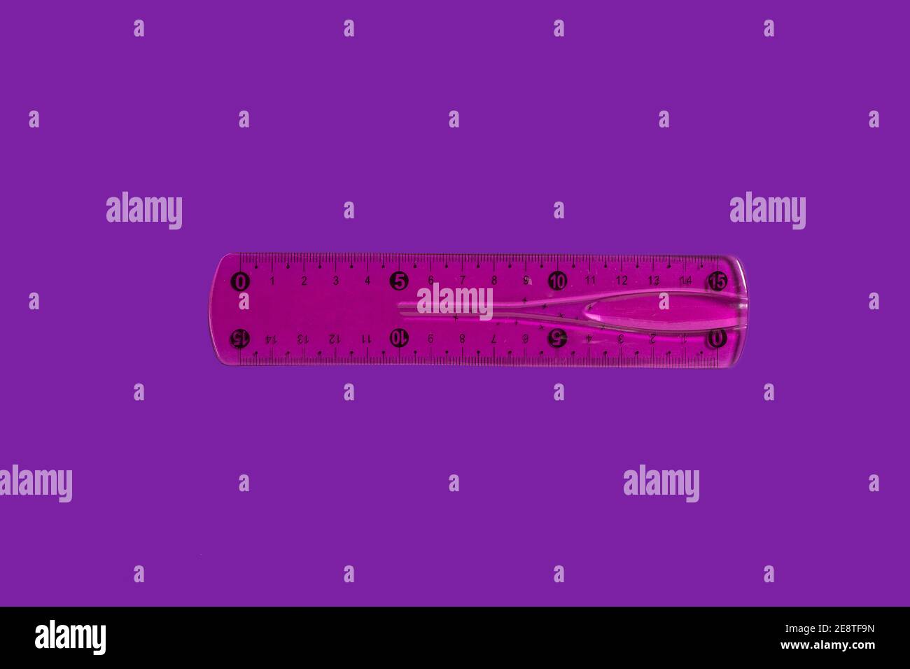 pink ruler on a purple background Stock Photo - Alamy