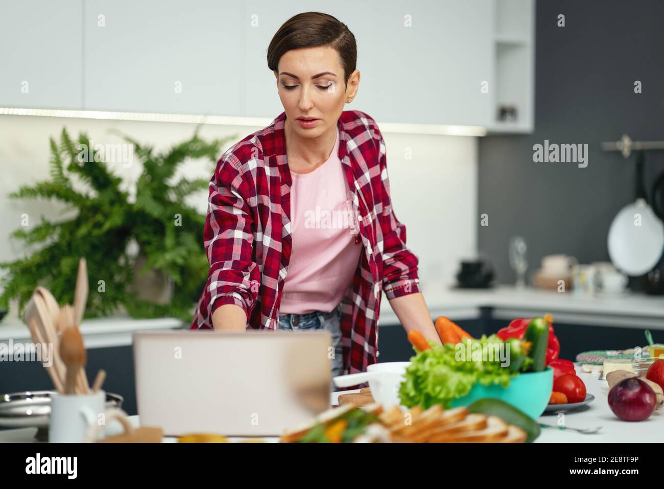 Making a video call using laptop computer housewife showing her new ...