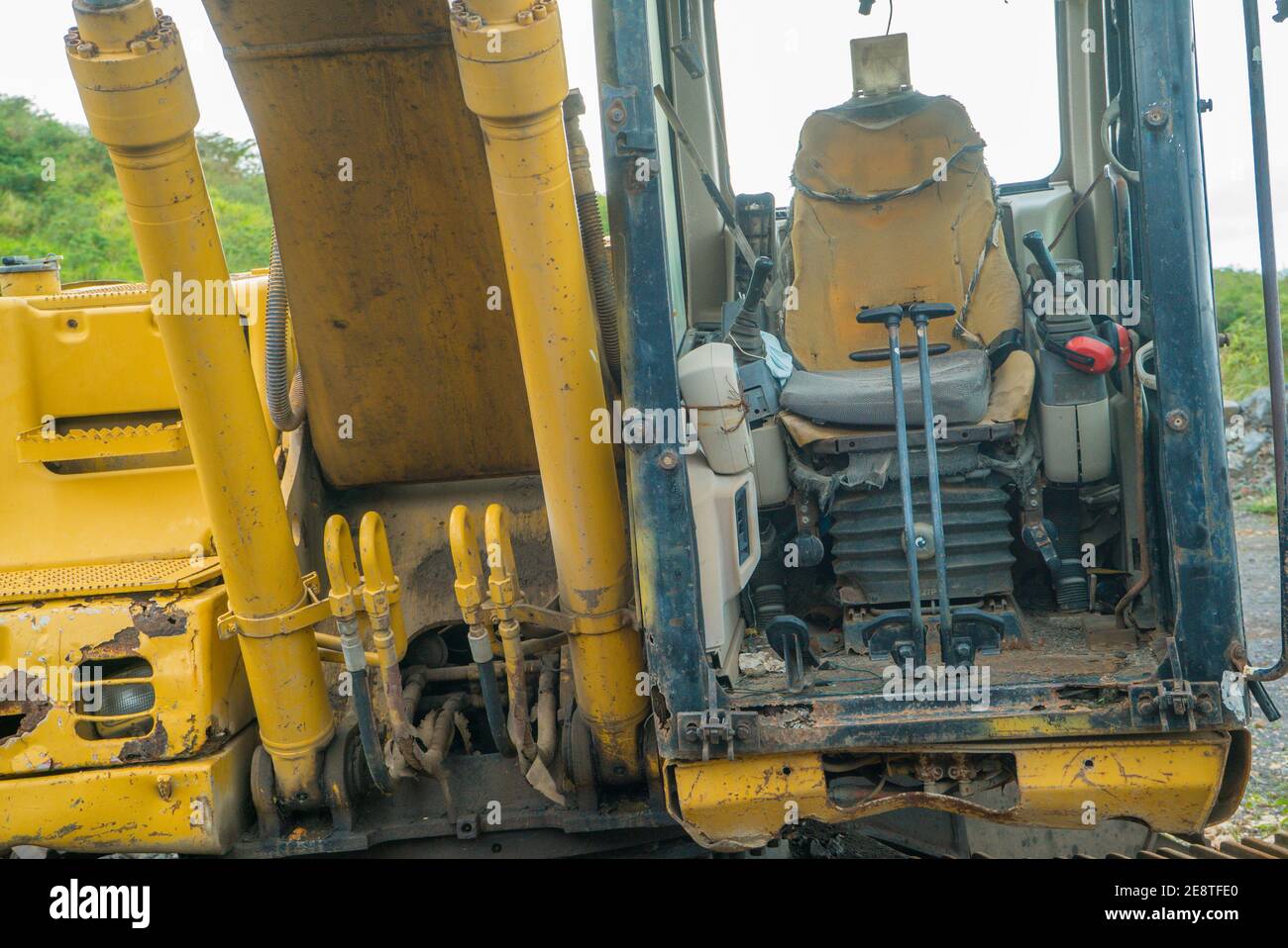 Bulldozer equip with drill, breaking down a hill landscape for homes ...