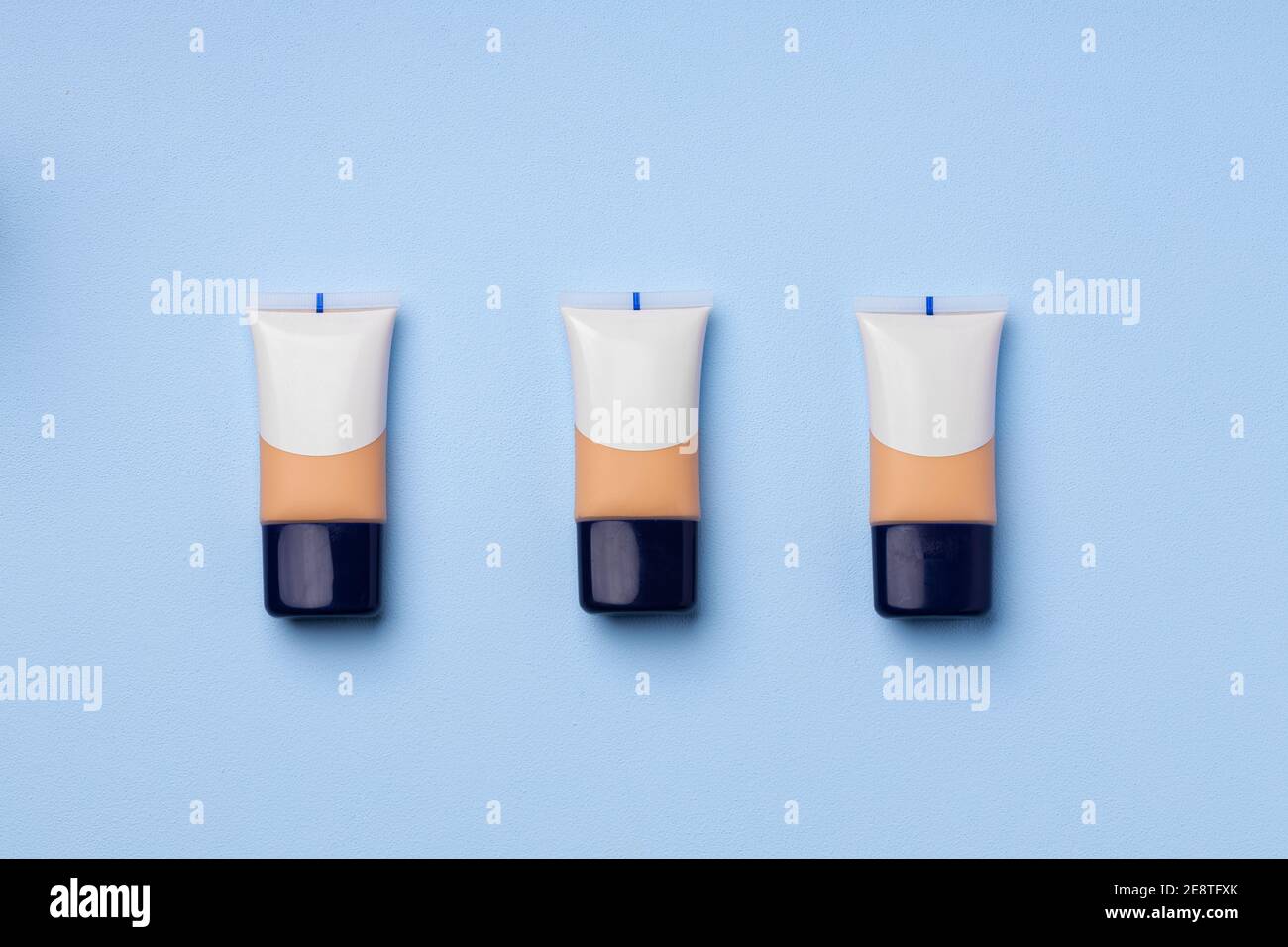 Liquid foundation tube on blue background close up Stock Photo - Alamy