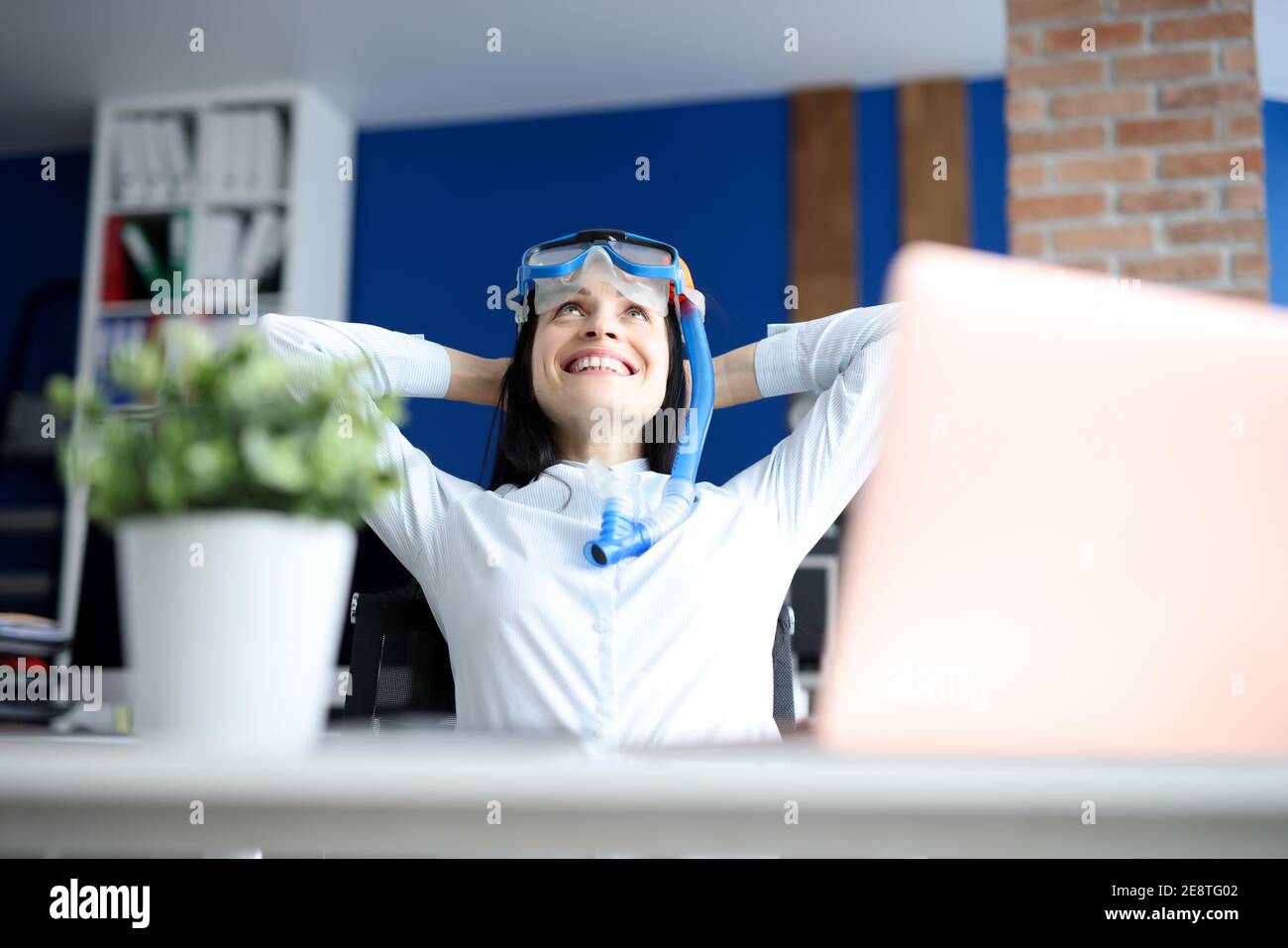 Woman in diving mask dreaming of sea at workplace Stock Photo - Alamy