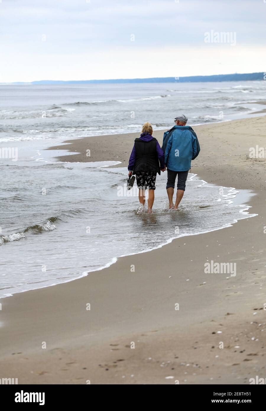Active and healthy lifestyle. Walking on a sandy beach sea shore Stock ...