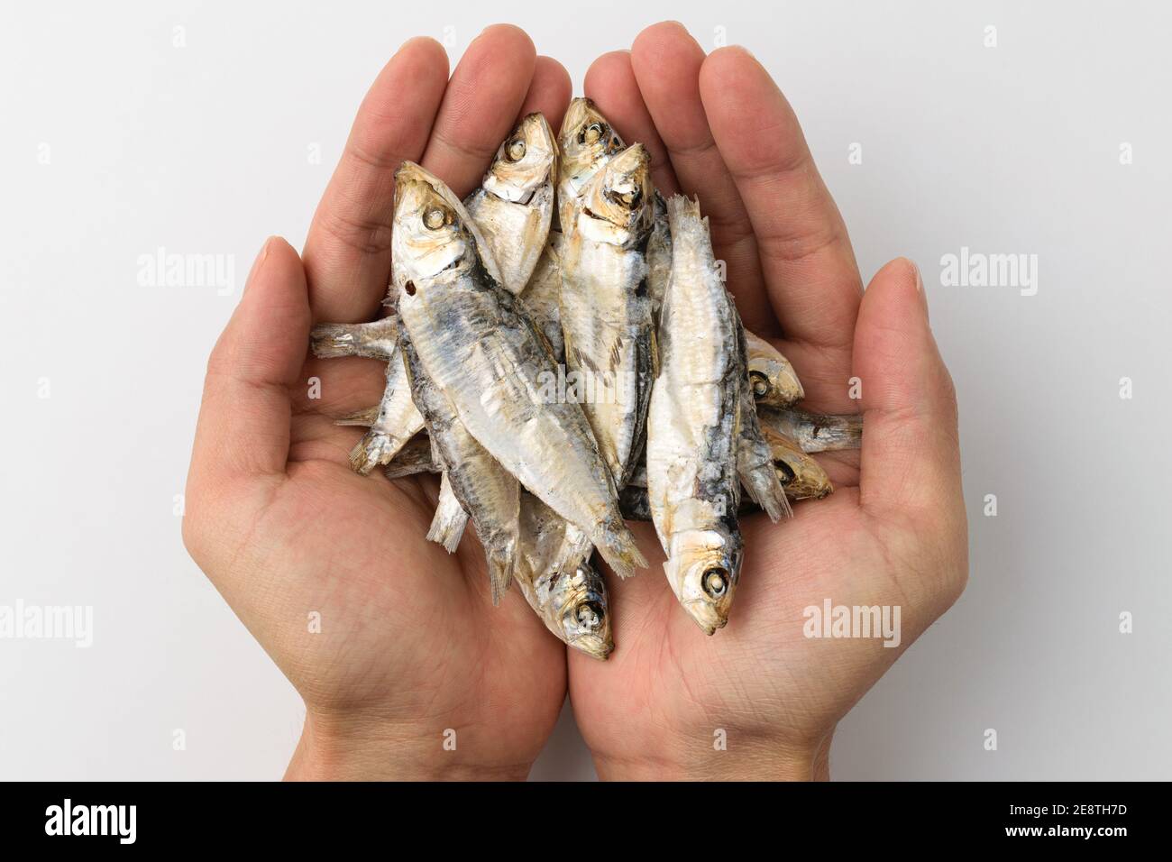 Dried herring on white background Stock Photo - Alamy