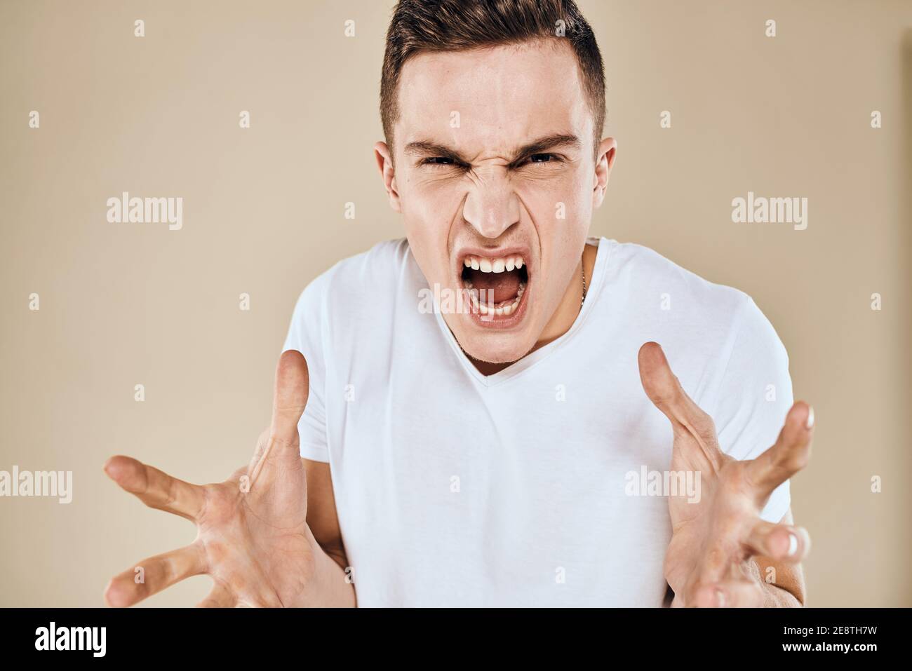 Man with displeased facial expression emotions white t-shirt gestures ...