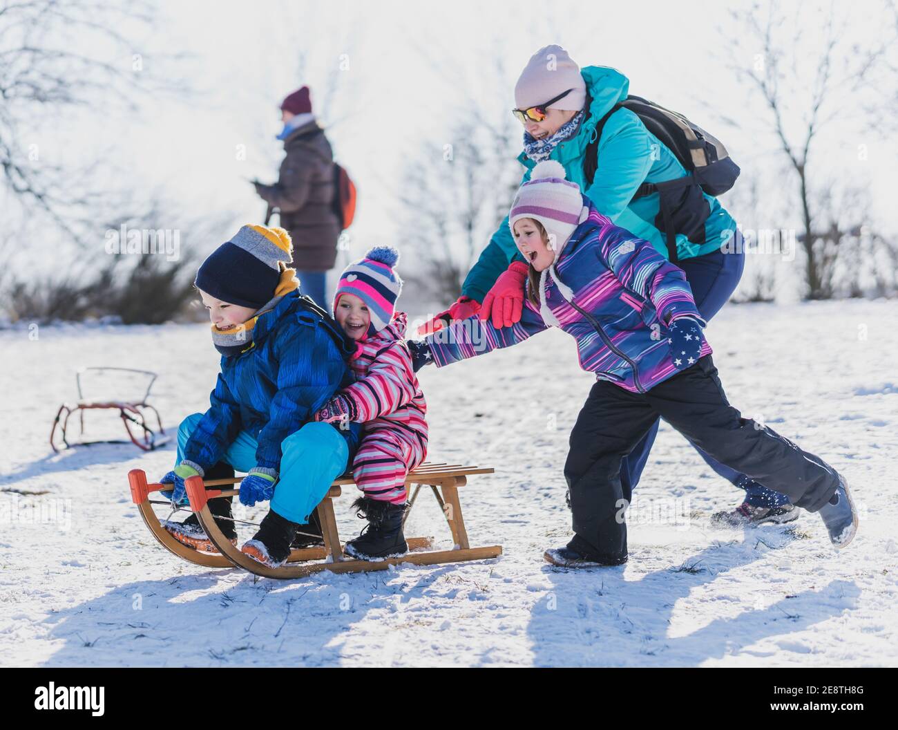 Boy pushing sled hi-res stock photography and images - Alamy