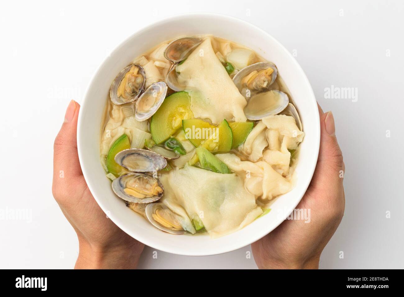 Cooking clam flour broth on a white background Stock Photo - Alamy