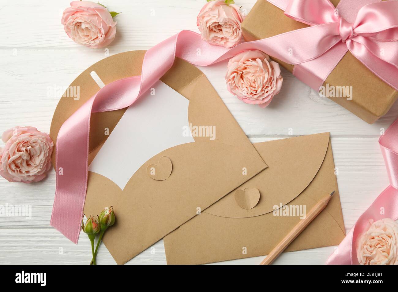 8 march concept with gift box and envelopes on white wooden background ...