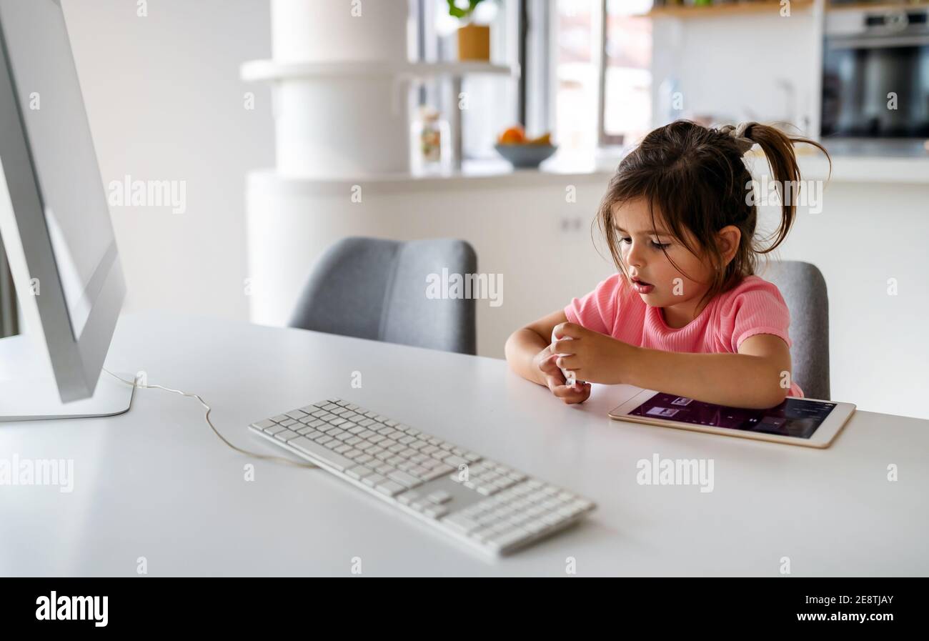 Little addicted child playing with technology devices at home Stock ...