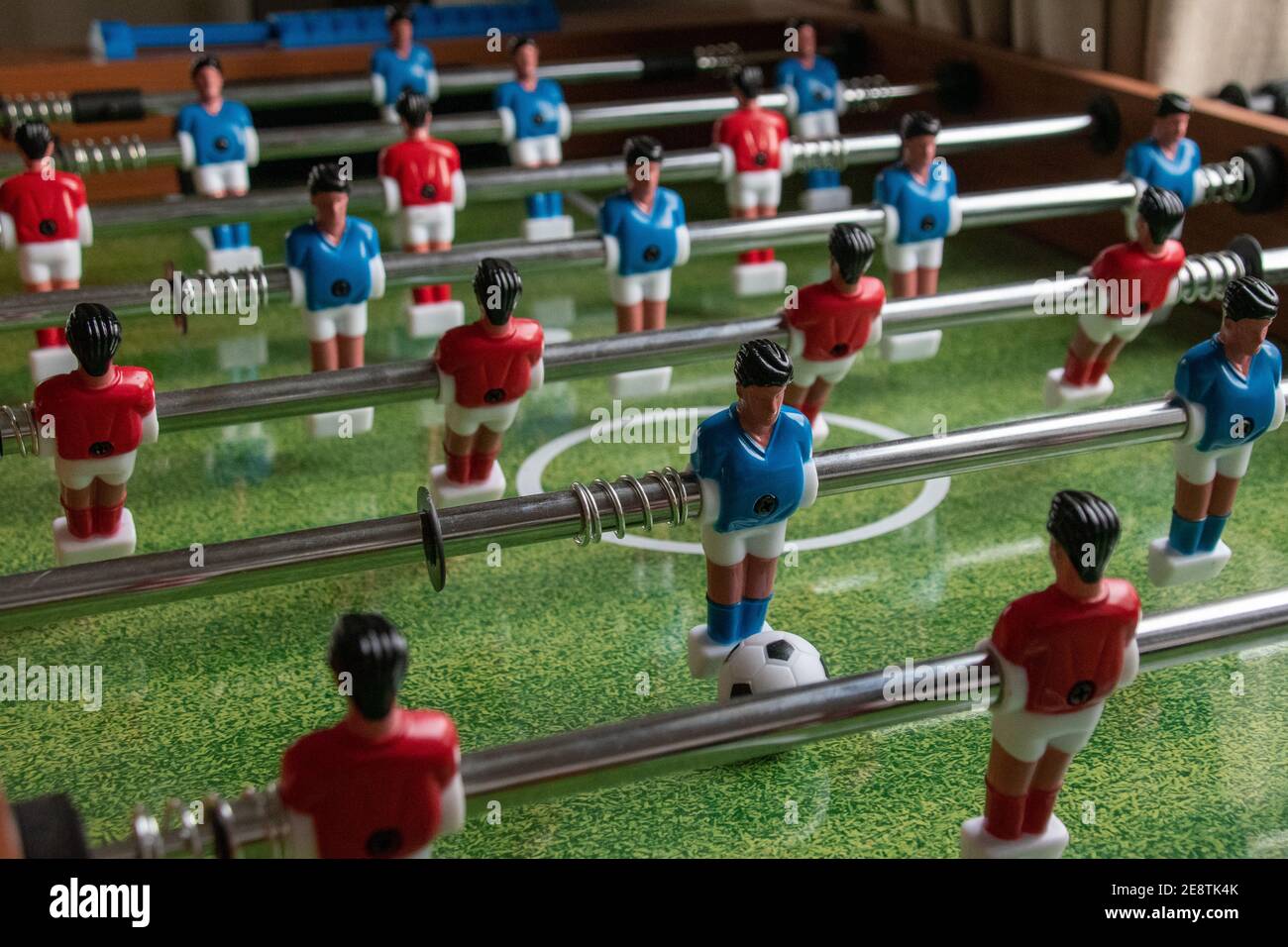 Table football, also known as table soccer, or foosball, with blue and ...