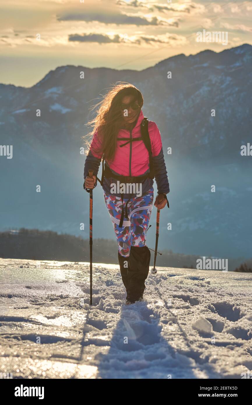 Girl walks in the snow during an alpine trek Stock Photo - Alamy